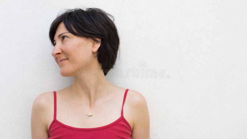 Young Woman Standing in Front of a White Wall Stock Photo - Image of ...