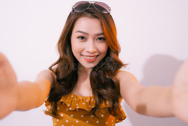 Young Woman Standing Isolated On Pastel Background Taking Selfie Photo