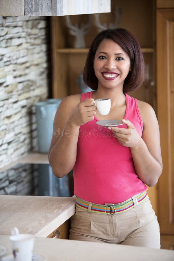 Young Woman Standing in Kitchen Drinking Coffee Stock Photo - Image of ...