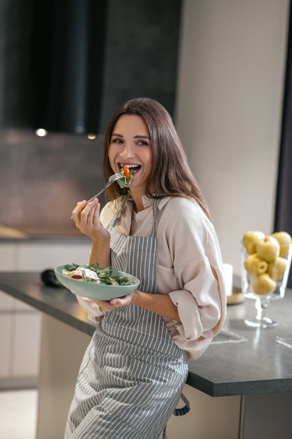 Young Woman Standing Near the Table with Plate in Hands Stock Photo ...