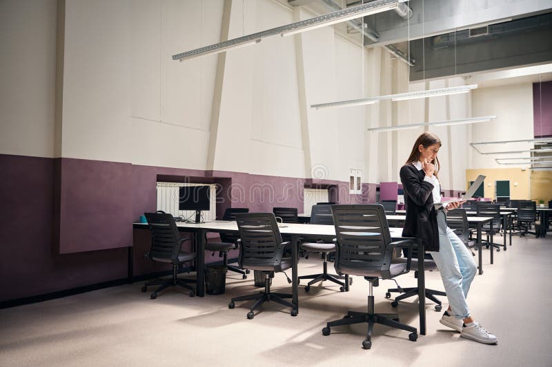 Young Woman Standing in Office Leaning on Table Stock Image - Image of ...