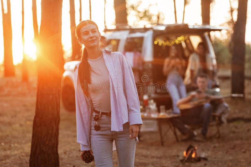 Young Woman is Standing and Posing. Group of Friends are Having Fun ...