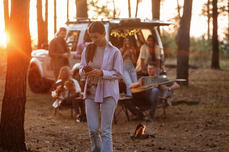 Young Woman is Standing and Posing. Group of Friends are Having Fun ...