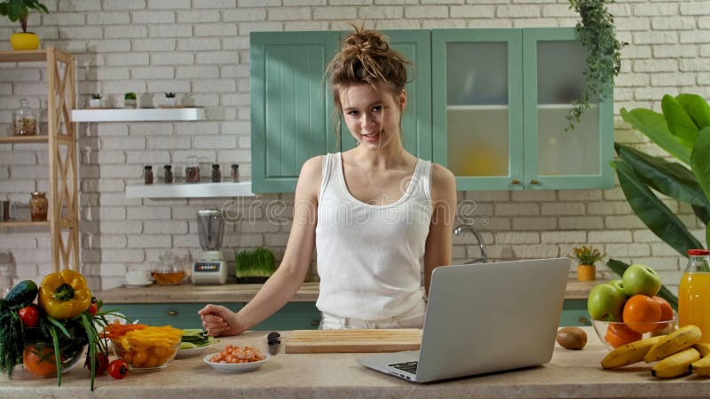 Young Woman Standing at the Table in the Kitchen Preparing Spring Rolls ...