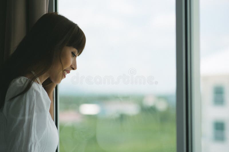 Young Woman Standing by Window at Home Stock Image - Image of elegant ...