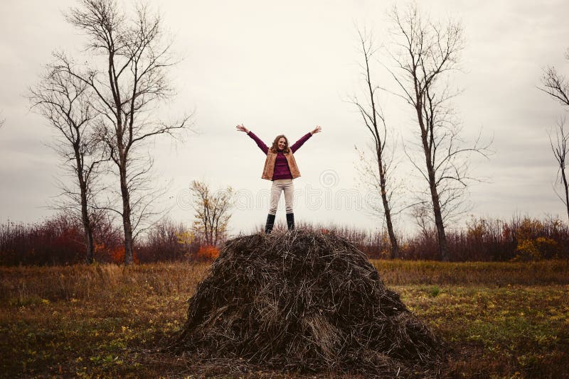 A Young Woman Stands on a Haystack in the Fall Stock Image - Image of ...
