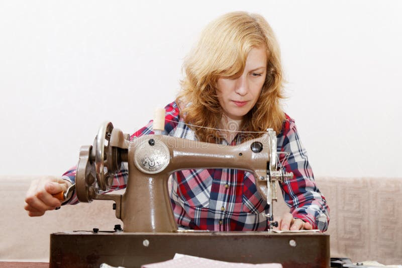 Young Woman Stitching Fabric Using a Sewing Machine Stock Photo - Image ...