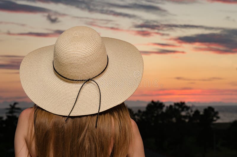 Young Woman in Straw Hat with Large Fields, Watching Sunset. Back View ...