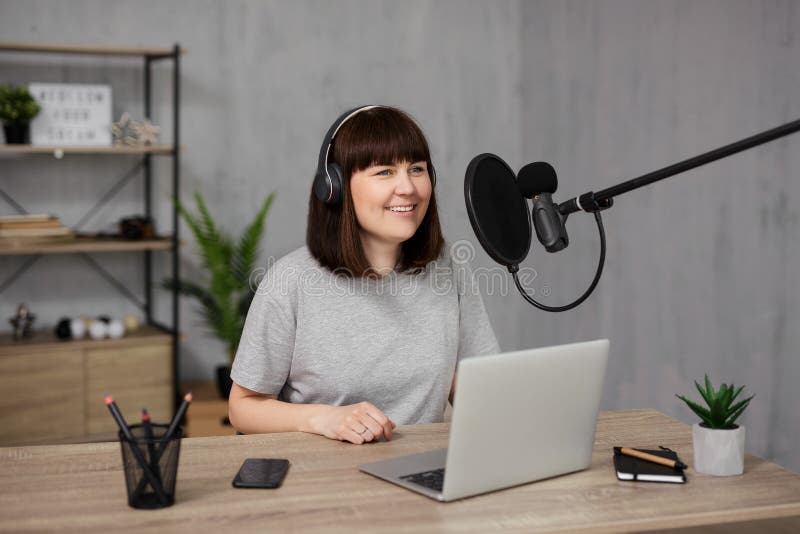Young Woman Streaming Her Audio Podcast Using Microphone and Laptop ...