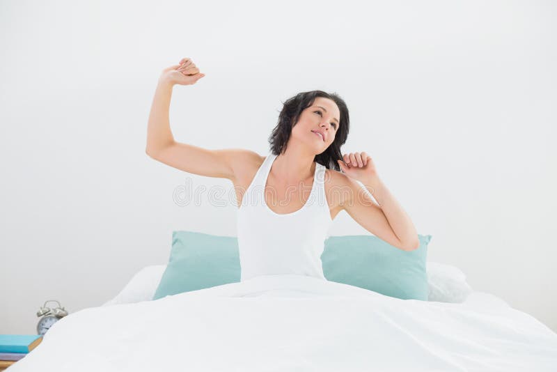Young Woman Stretching Arms in Bed Stock Photo - Image of space ...
