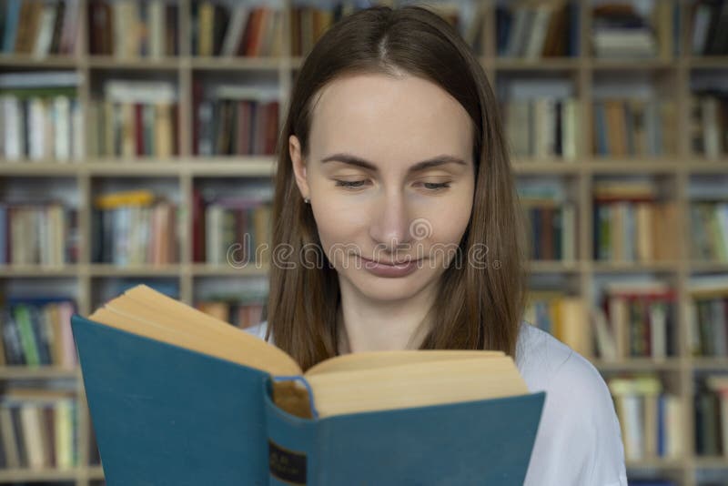 Young Woman Student Reading a Book in a Library Stock Image - Image of ...