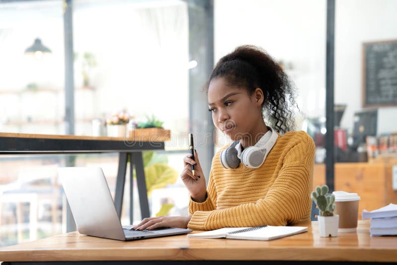Young Woman Student Using Computer and Mobile Device Studying Online ...