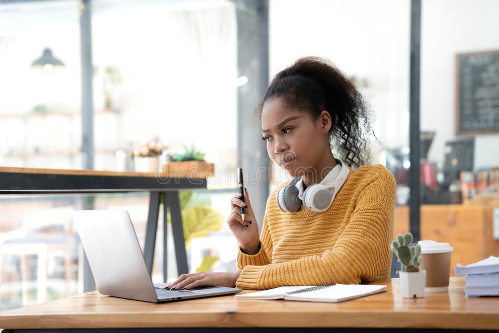 Young Woman Student Using Computer and Mobile Device Studying Online ...