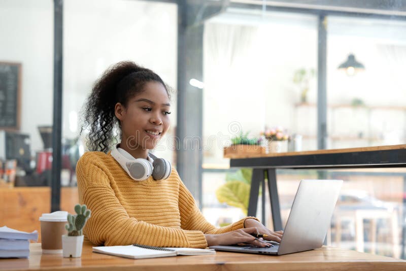 Young Woman Student Using Computer and Mobile Device Studying Online ...