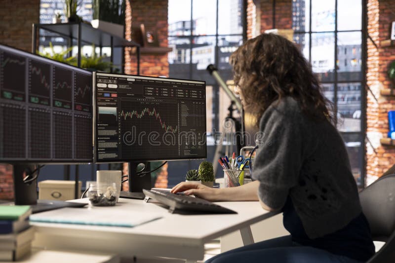 Young Woman Studies Stock Trading Charts on Her Computer Stock Image ...
