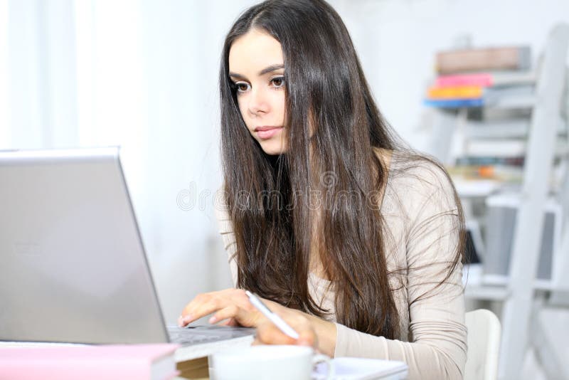 Young Woman Studying at the Computer and Takes Notes Stock Photo ...