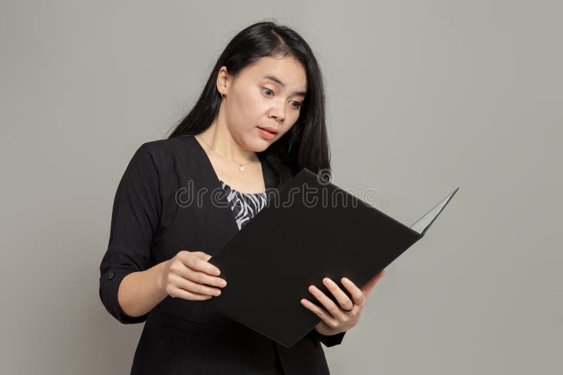Young Woman in Suit with Dumbfounded Expression while Holding and ...