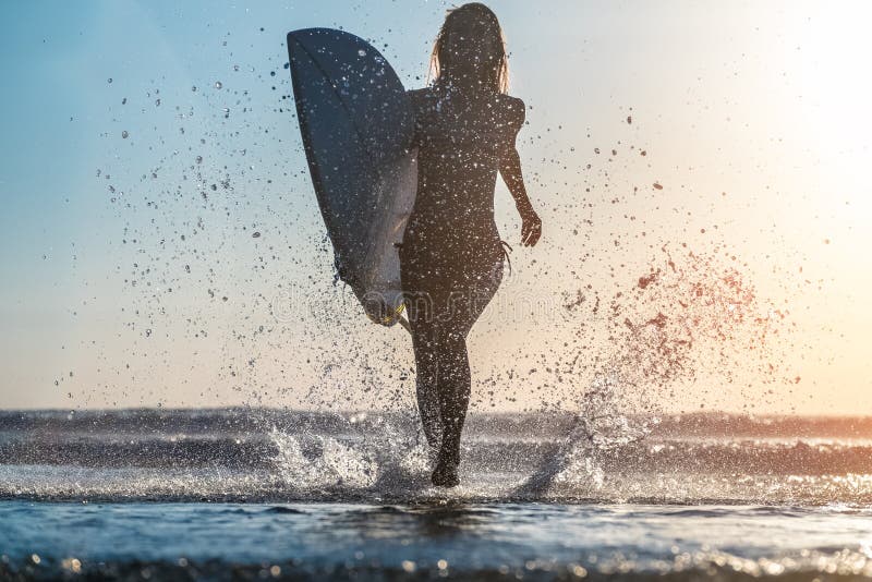 Woman with surfboard stock image. Image of adventure - 99227117
