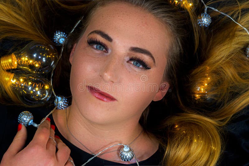 A Young Woman Surrounded by Lights Stock Photo - Image of face ...