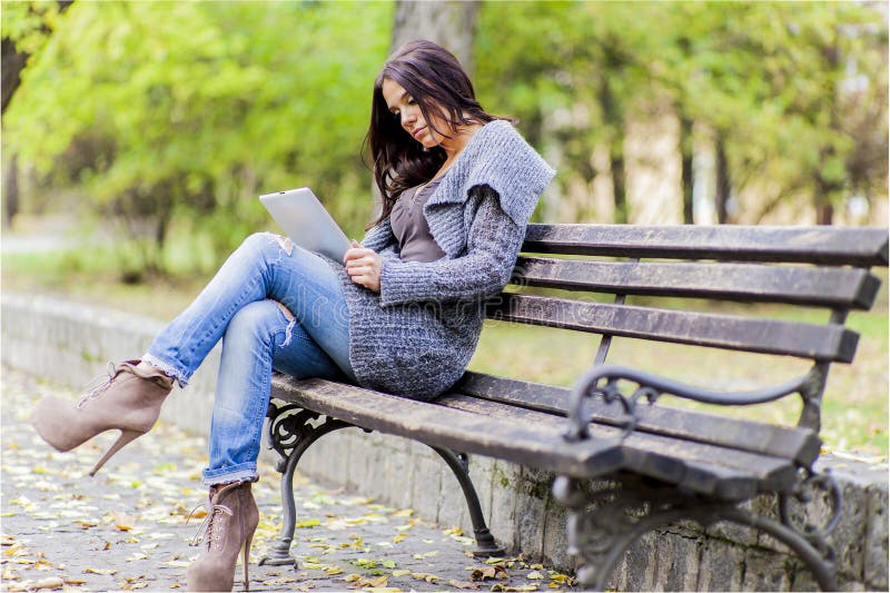 Young Woman with Tablet on the Bench Stock Photo - Image of sitting ...