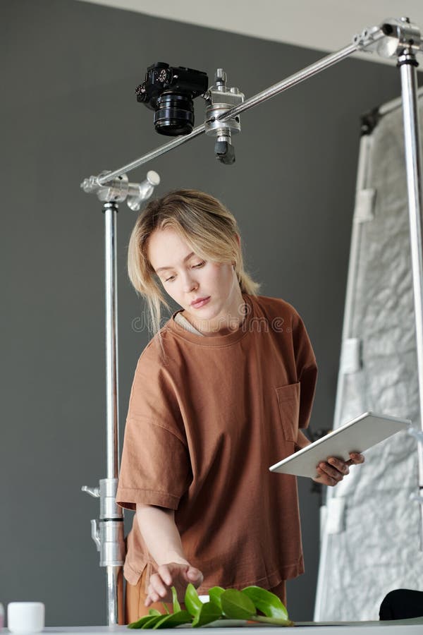 Young Woman with Tablet Bending Over Table while Making Composition ...