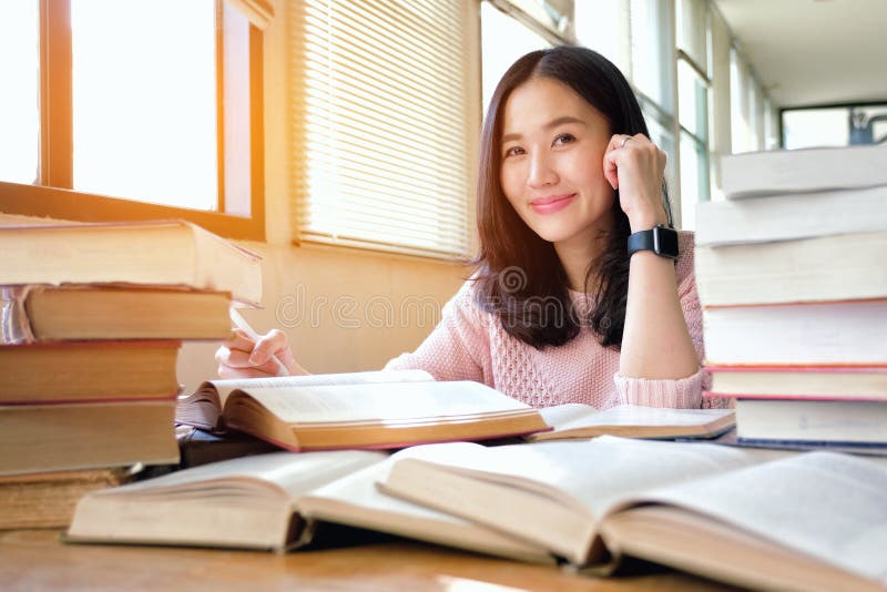 Young Woman Taking Note and Studying in Library Stock Image - Image of ...