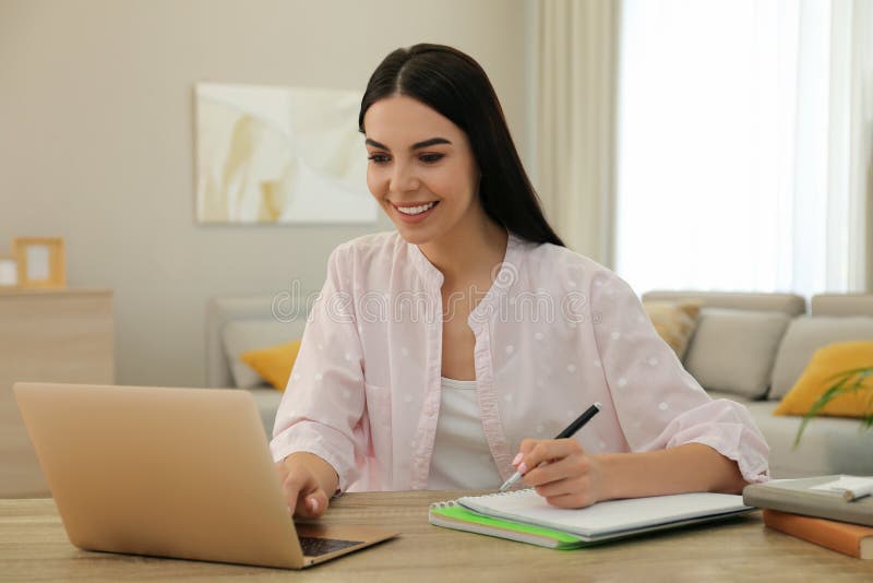 Young Woman Taking Notes during Online Webinar at Table Stock Image ...