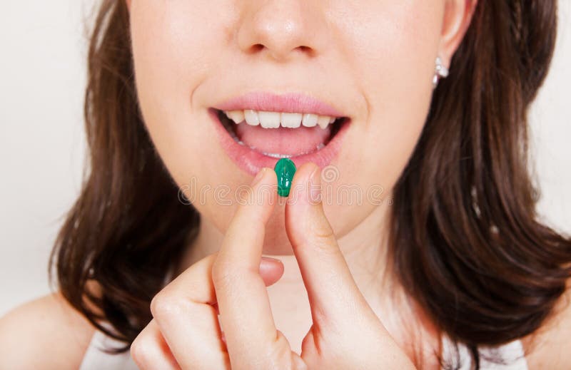 Young woman taking pills stock photo. Image of addiction - 25836328