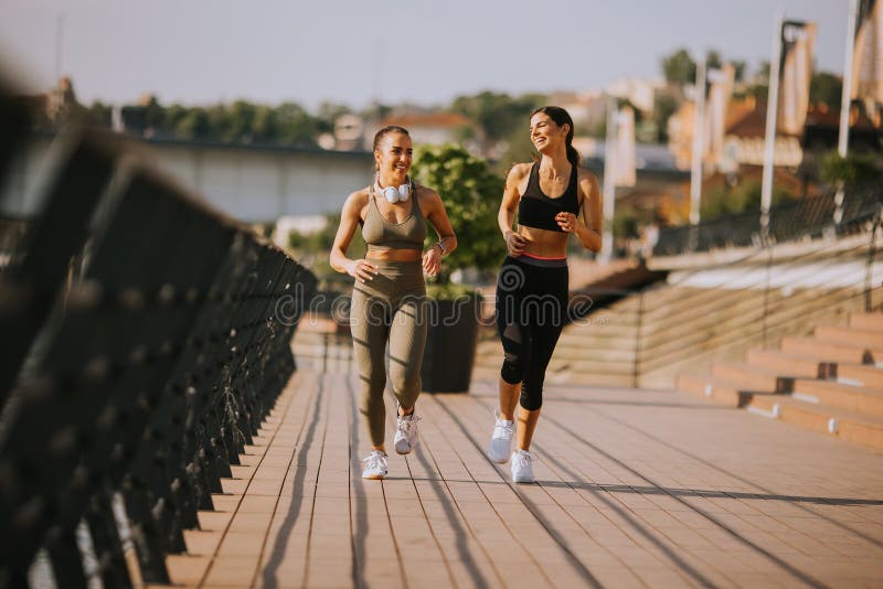 Young Woman Taking Running Exercise by the River Promenade Stock Photo ...
