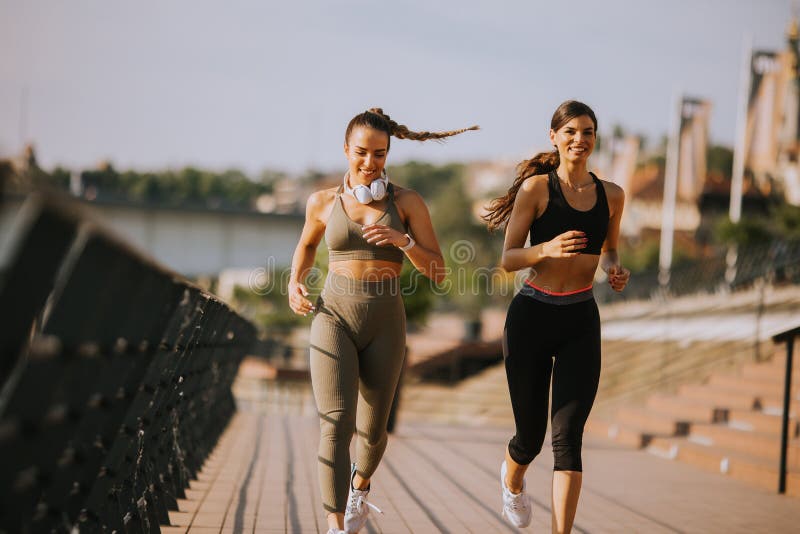 Young Woman Taking Running Exercise by the River Promenade Stock Image ...