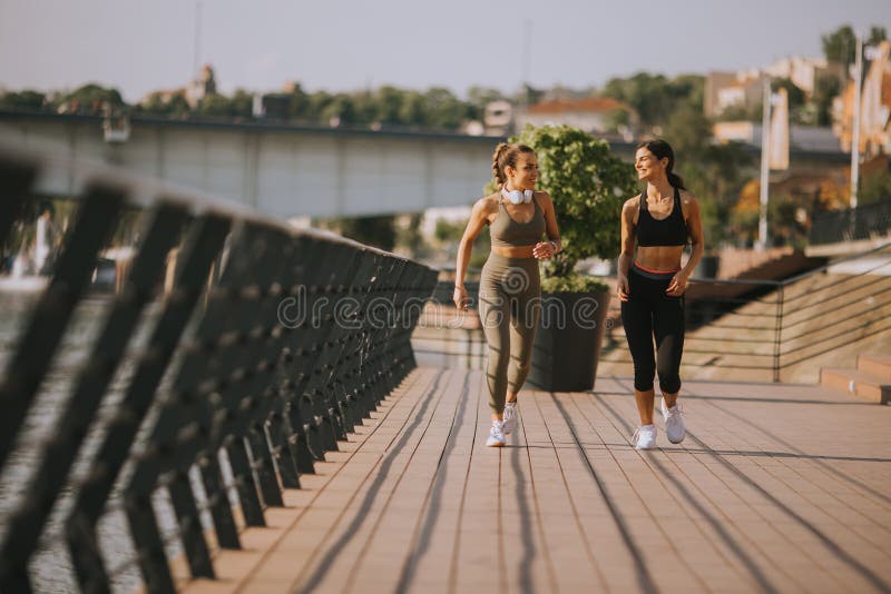 Young Woman Taking Running Exercise by the River Promenade Stock Image ...