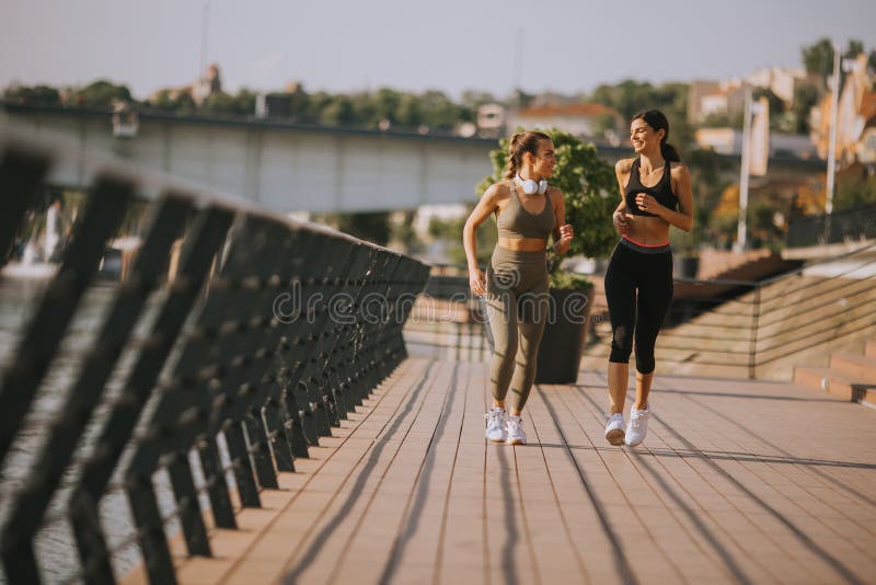 Young Woman Taking Running Exercise by the River Promenade Stock Photo ...