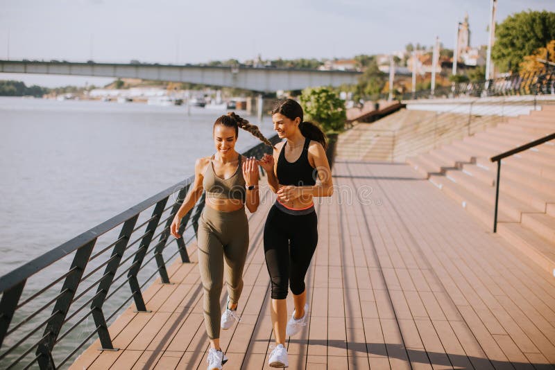 Young Woman Taking Running Exercise by the River Promenade Stock Photo ...