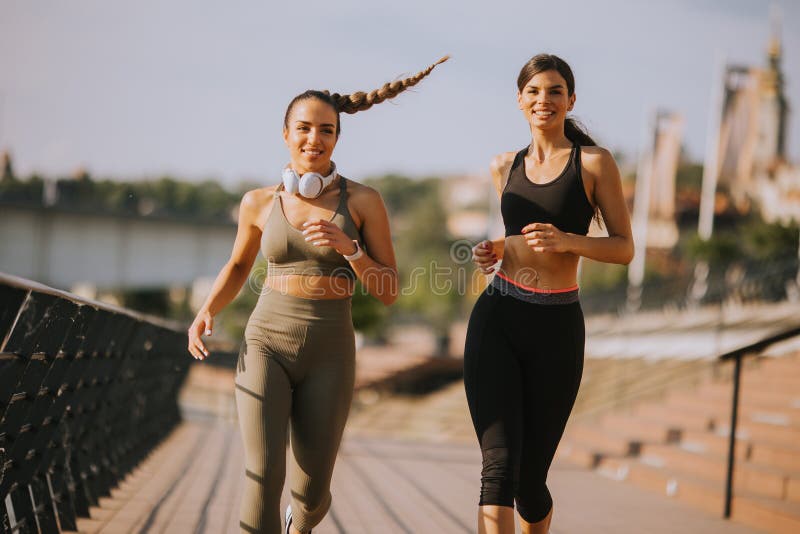 Young Woman Taking Running Exercise by the River Promenade Stock Photo ...