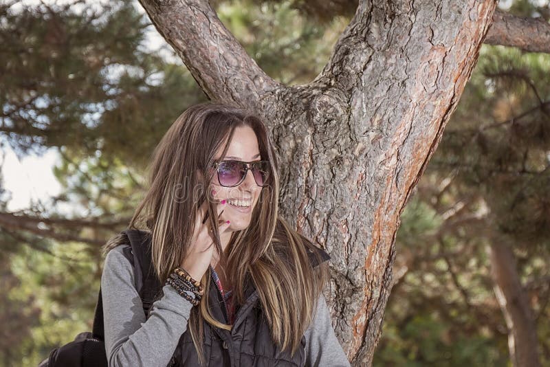 Young Woman Talking on the Phone Outside Under a Tree Stock Photo ...