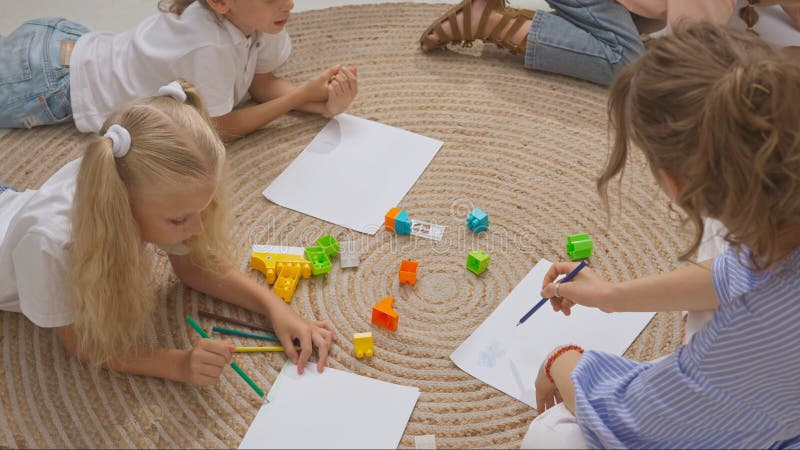 Young Woman Teacher and Group of Children Doing Creative Tasks in ...