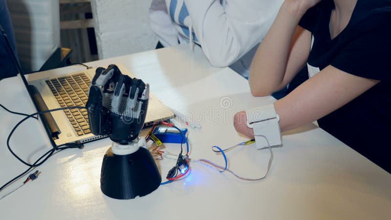 Woman with Innovative Cybernetic Bionic Arm. Disabled Woman Operates ...
