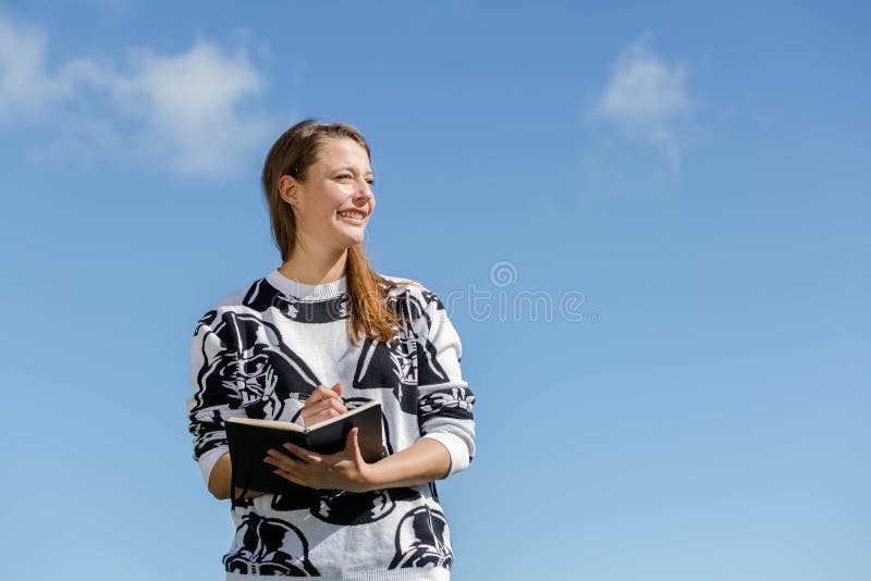 Young Woman is Thinking and Taking Notes Stock Photo - Image of face ...