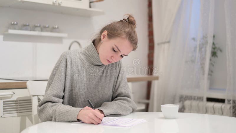 Young Woman Thinking and Writing on Paper at Home Stock Photo - Image ...