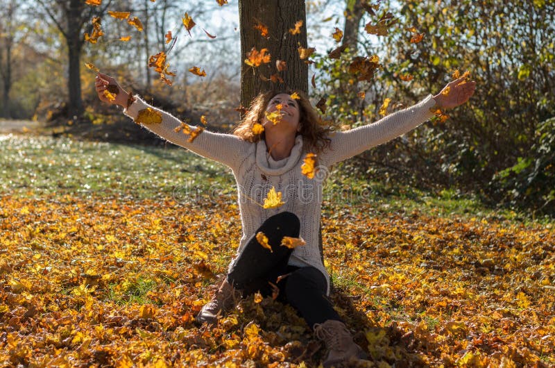 Young Woman Throwing Leaves in the Air Stock Photo - Image of curly ...