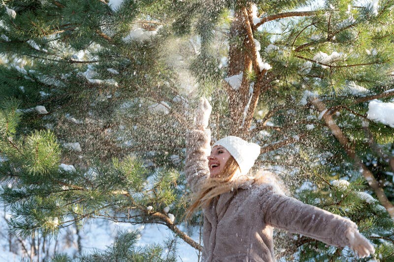 Young Woman Throwing Snow in the Air in the Winter Forest. Snowfall ...