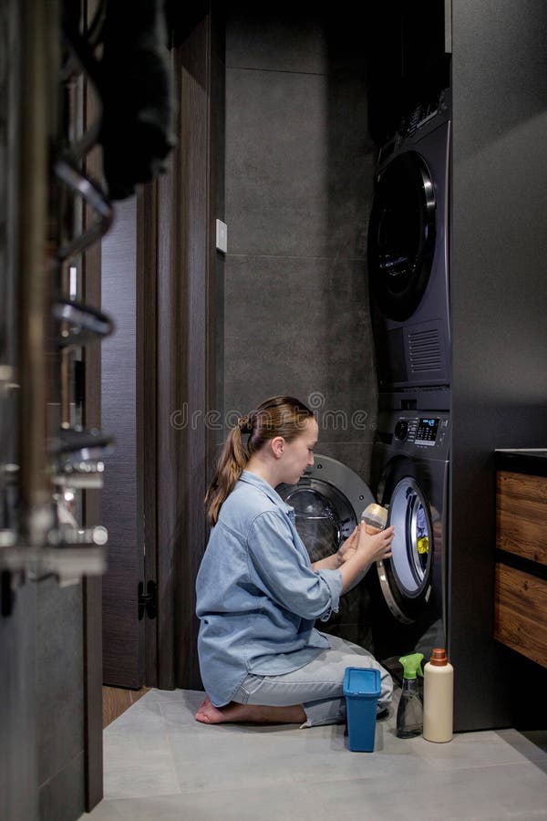 Young Woman Throws Conditioner in Granules into the Washing Machine ...