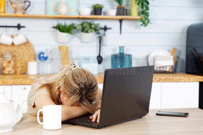 Young Woman Tired and Fell Asleep at the Kitchen Table with the Laptop ...