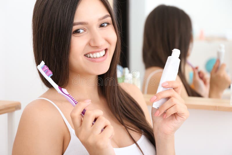 Young Woman with Toothpaste and Brush in Bathroom Stock Image - Image ...