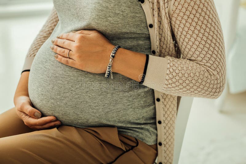 Young Woman Touching Her Third-trimester Pregnant Belly Stock Photo ...