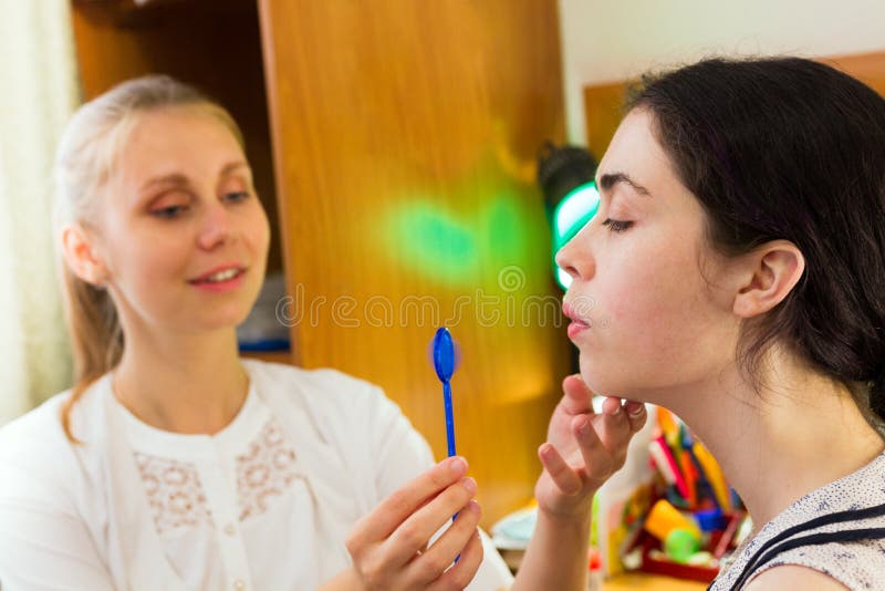 Young Woman Trains with Speech Therapy Probe in Soft Focus Stock Photo ...