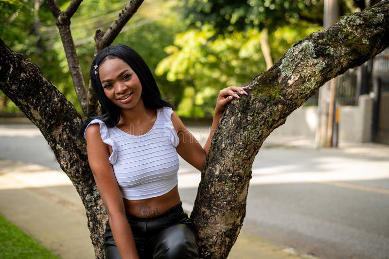 Young woman in tree stock photo. Image of pretty, smiling - 264120224