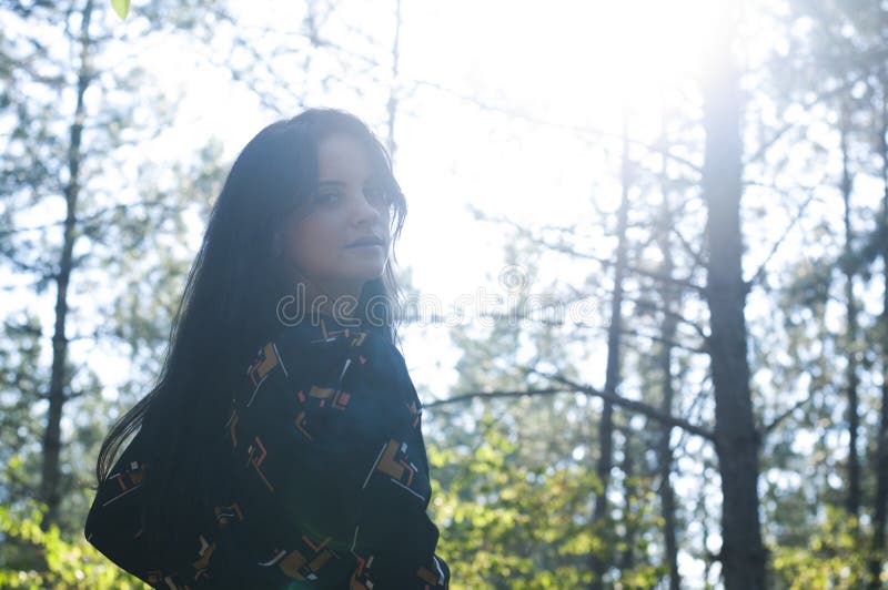 Young Woman among the Trees Looks Back. in the Woods Stock Photo ...