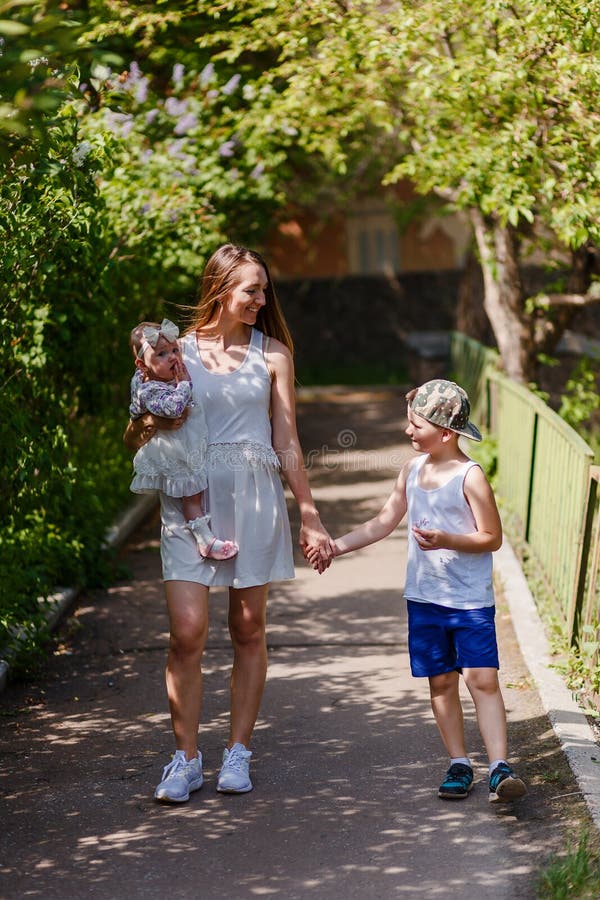 Young Woman with Two Children in the Summer Stock Photo - Image of ...