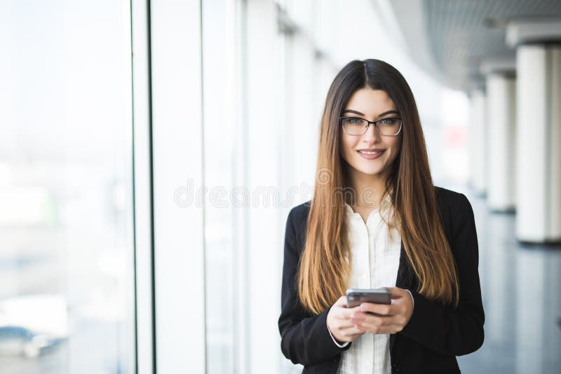 Young Woman with Typing on Mobile Phone in the Office Stock Photo ...